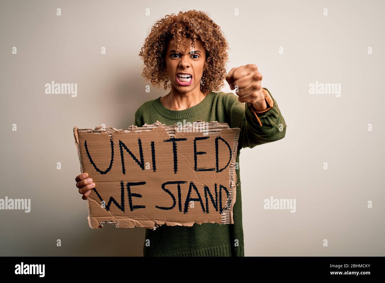 African american activist woman asking for unity holding banner with ...