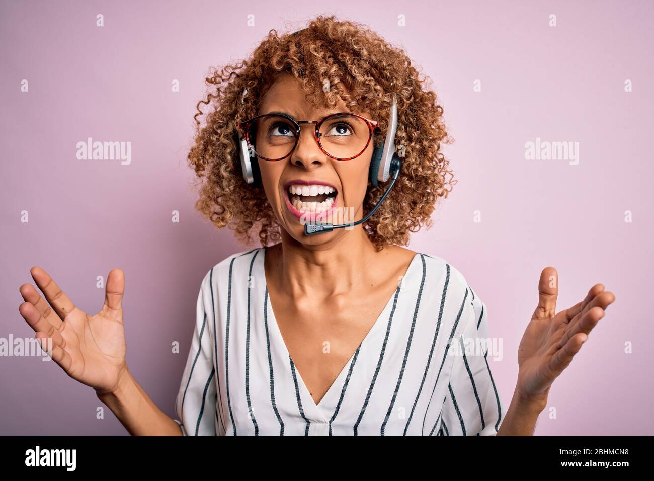 African american curly call center agent woman working using headset ...