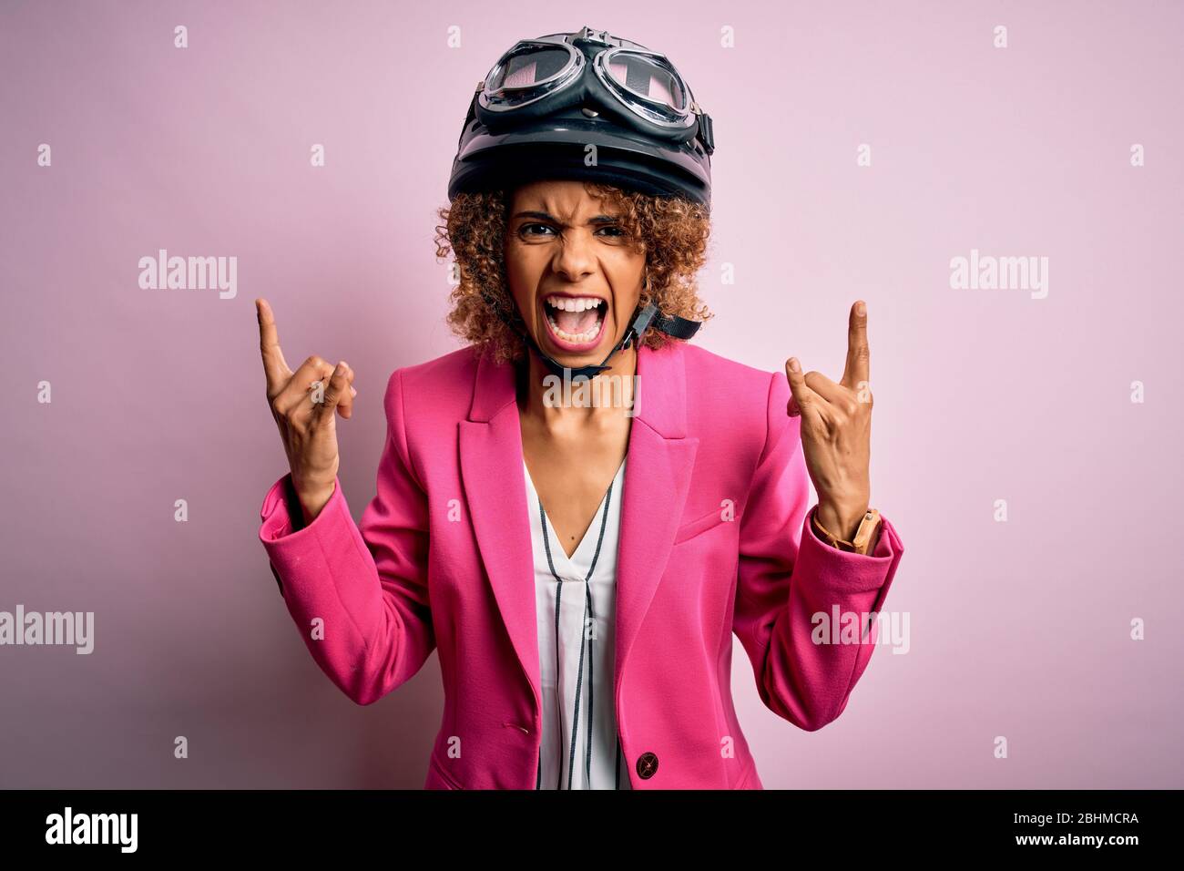 African american motorcyclist woman with curly hair wearing moto helmet ...