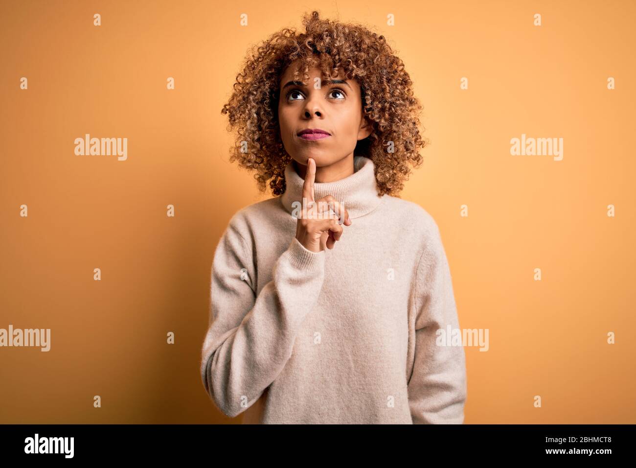 Young beautiful african american woman wearing turtleneck sweater over ...