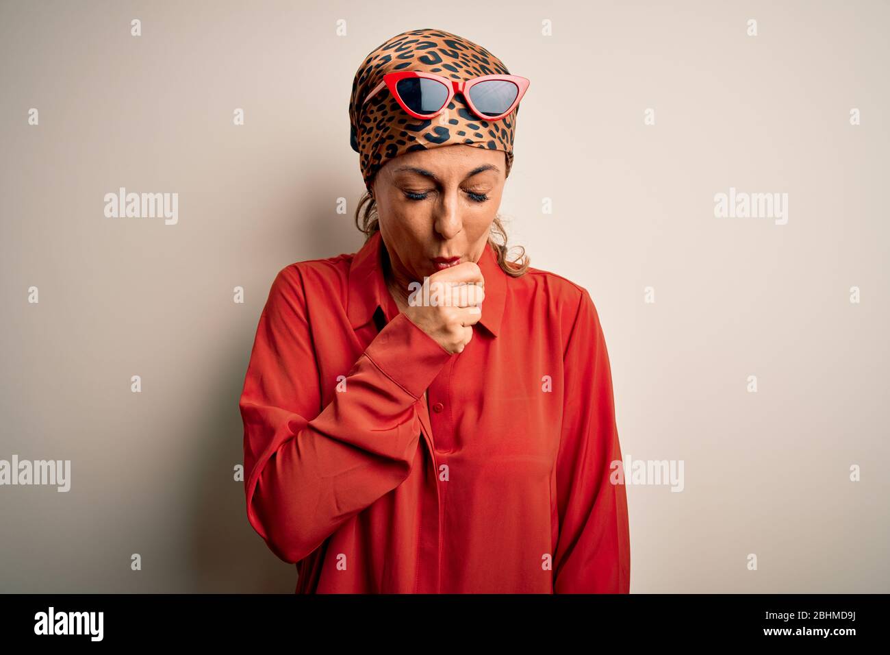 Middle age brunette woman wearing handkerchief on head and shirt over ...