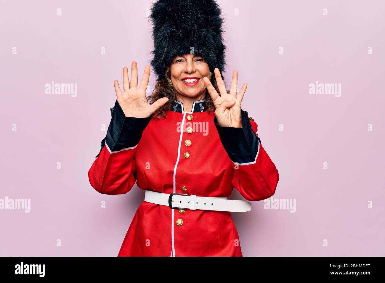 Middle age beautiful wales guard woman wearing traditional uniform over ...