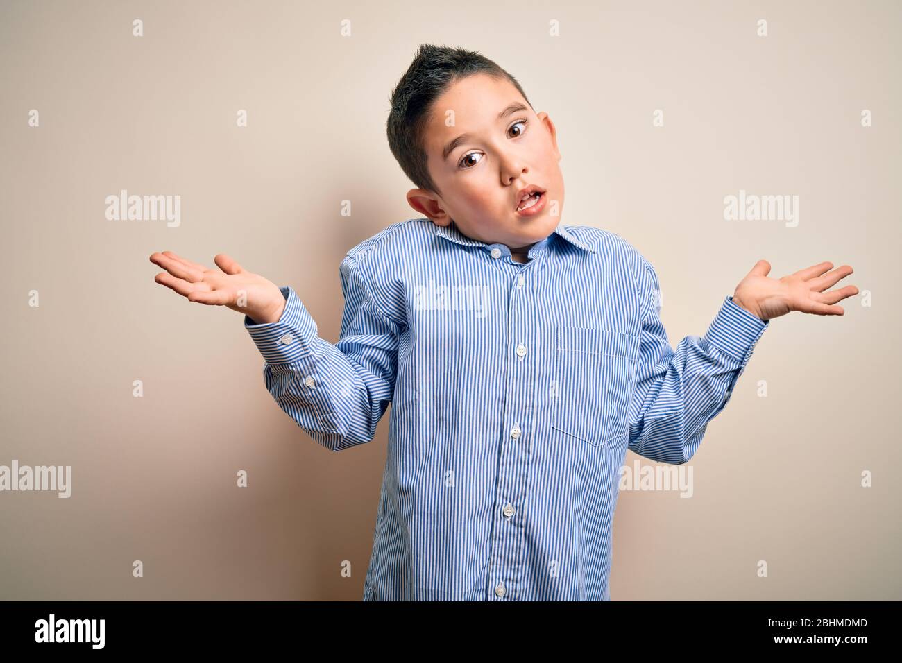 Young little boy kid wearing elegant shirt standing over isolated ...