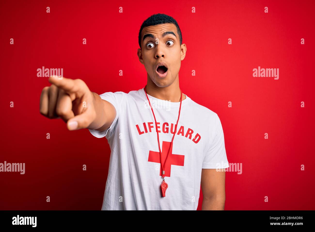 Young handsome african american lifeguard man wearing t-shirt with red ...