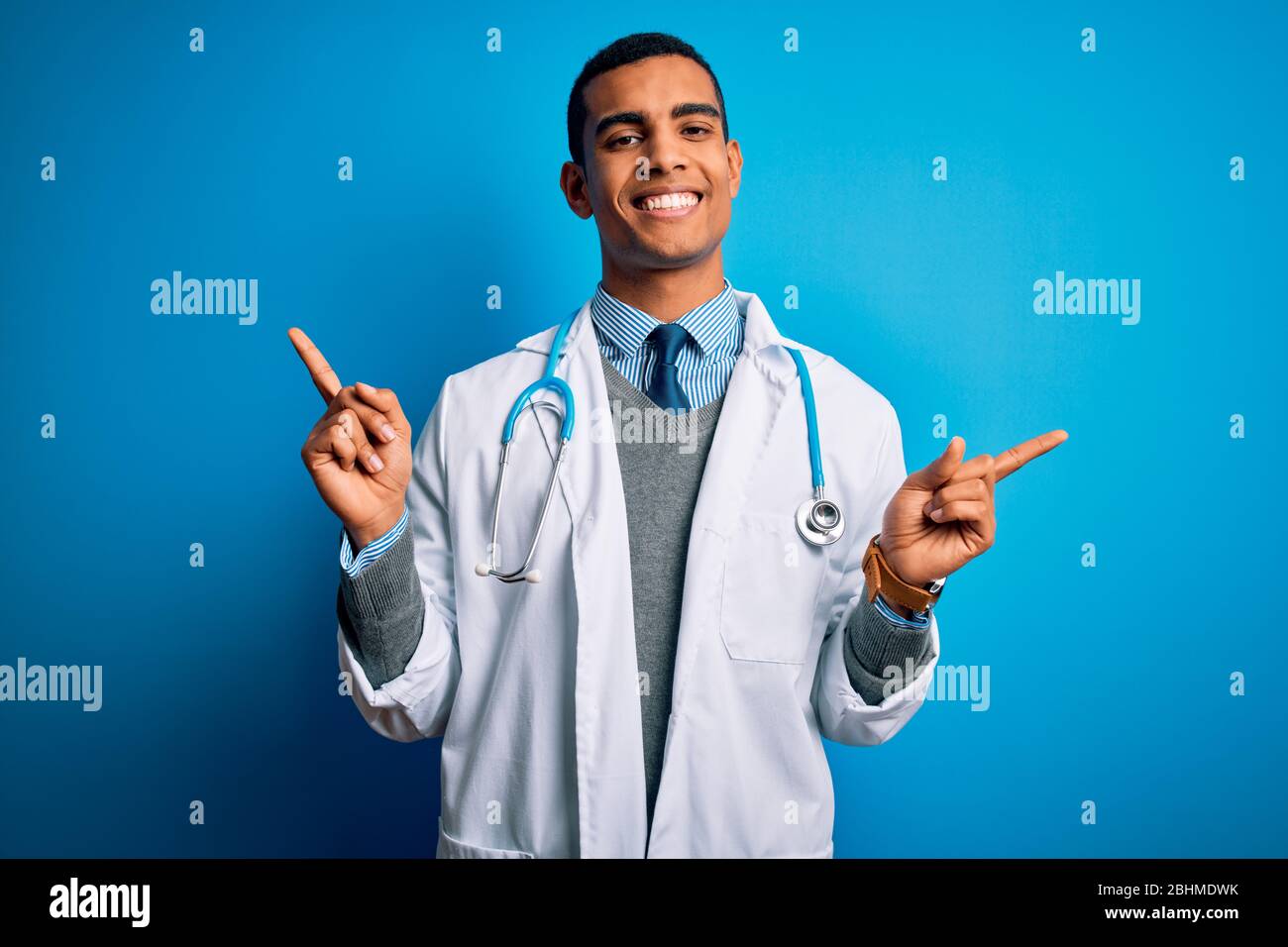 Handsome african american doctor man wearing coat and stethoscope over ...