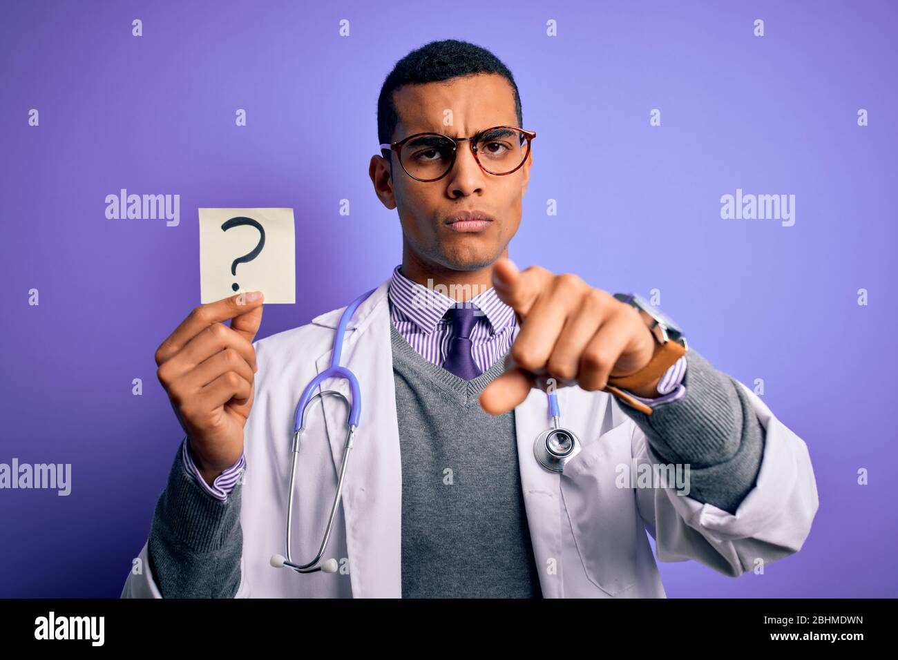 Handsome african american doctor man wearing stethoscope holding ...