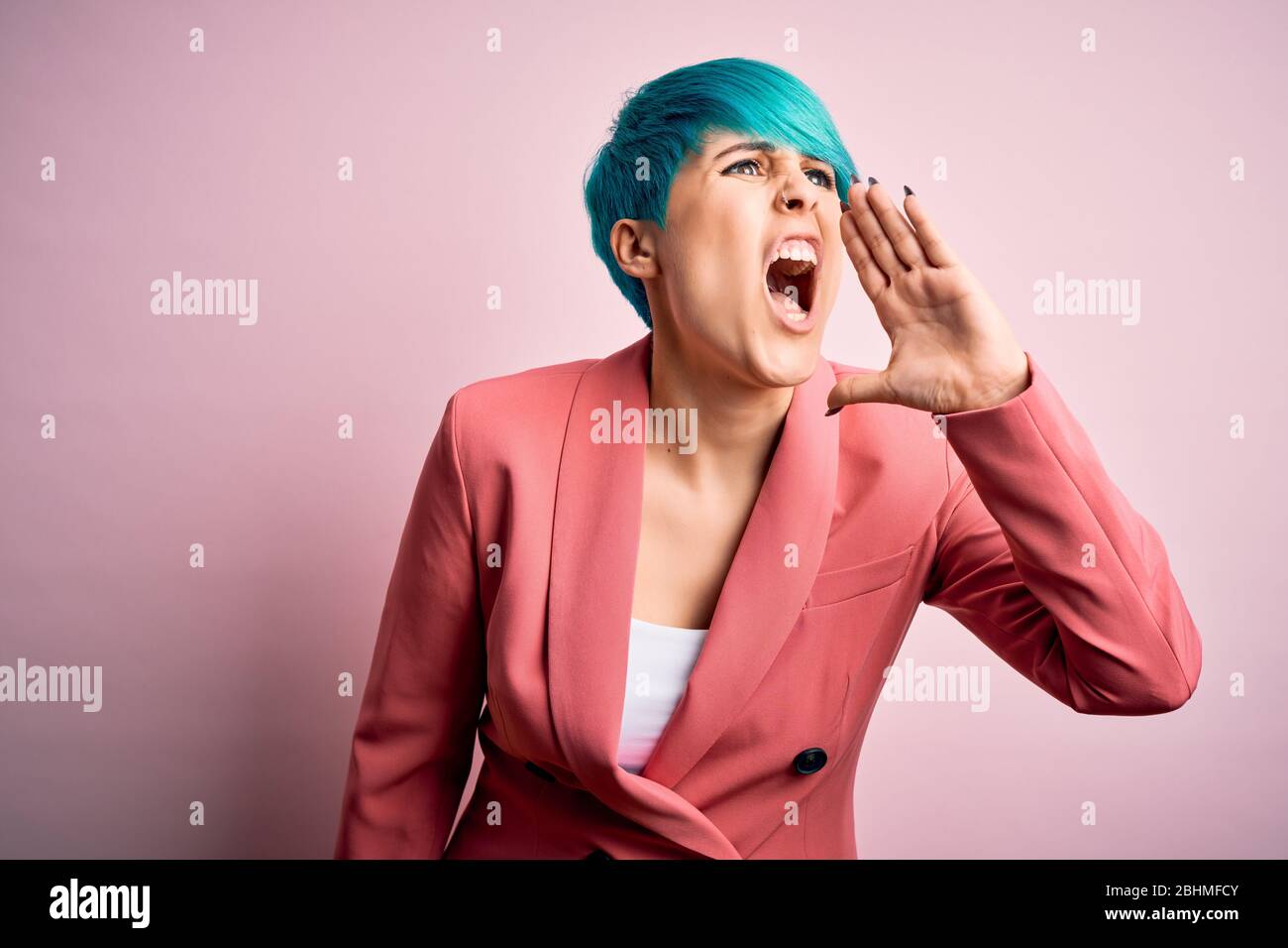Young beautiful businesswoman with blue fashion hair wearing jacket ...
