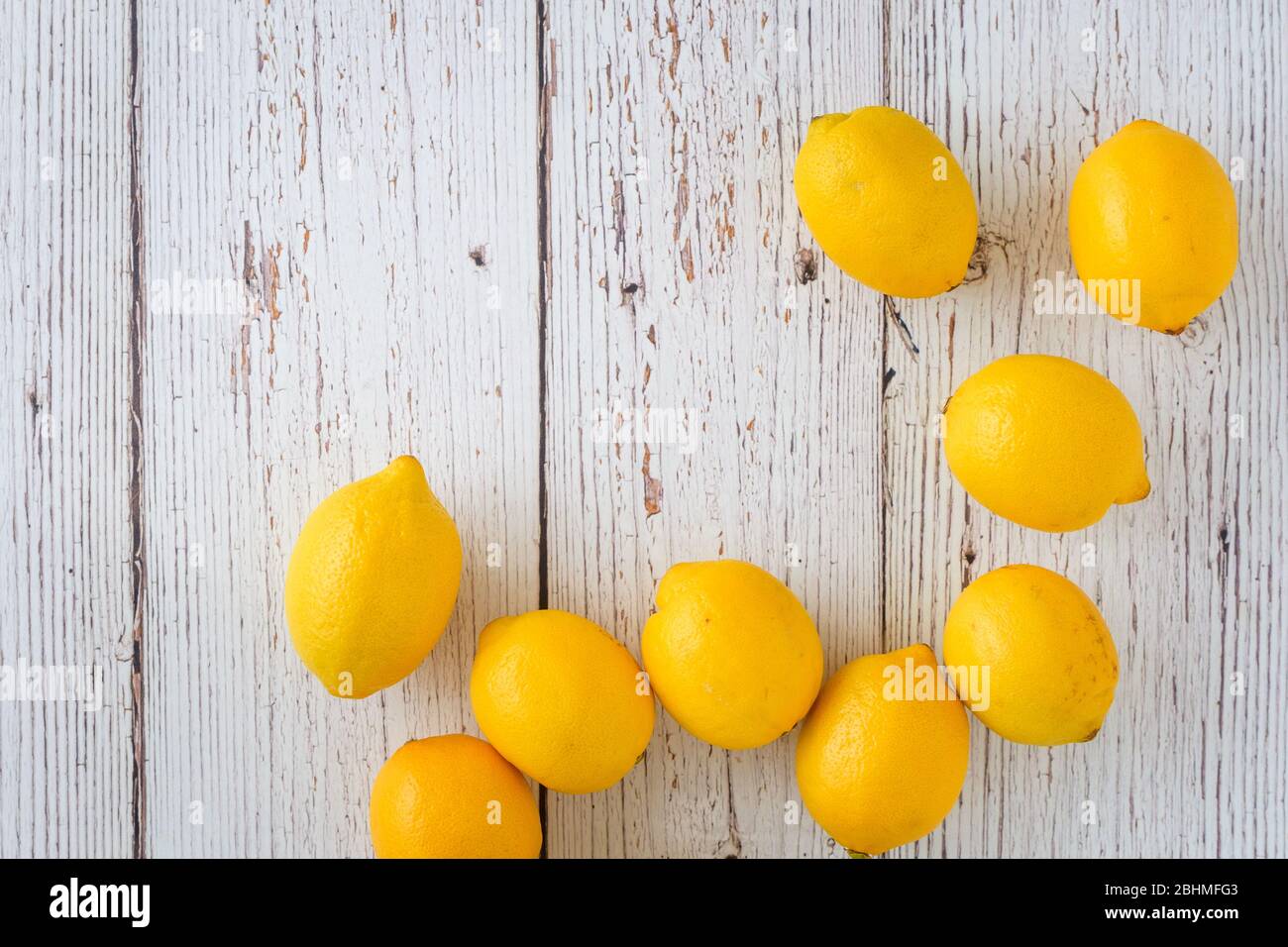 Lemons spilled onto a whitewashed wood background Stock Photo - Alamy
