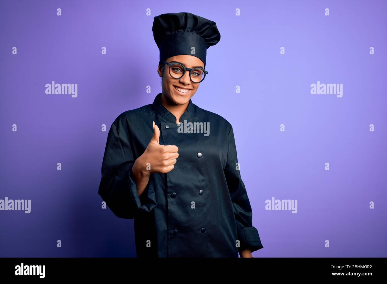 Young african american chef girl wearing cooker uniform and hat over ...