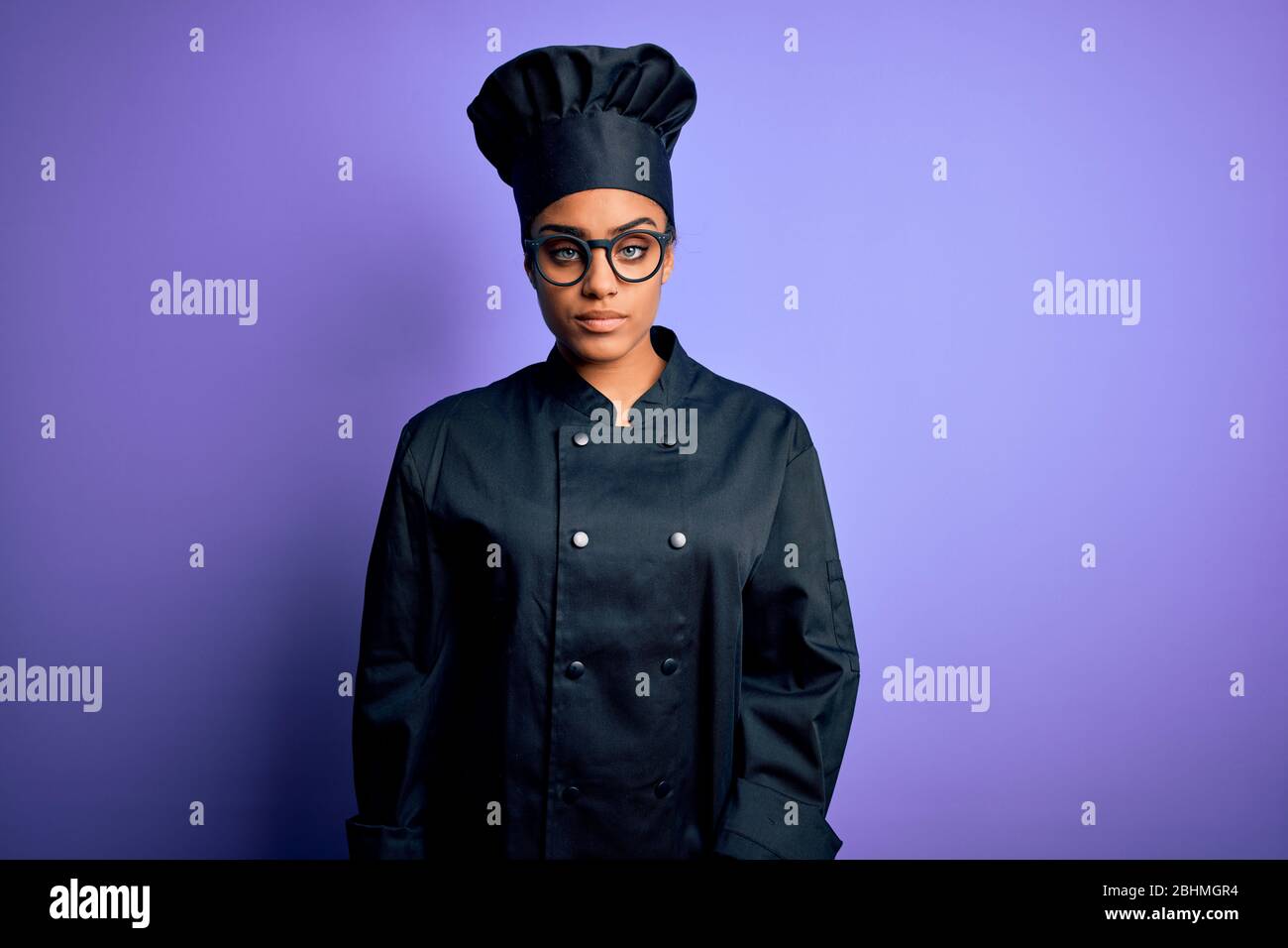 Young african american chef girl wearing cooker uniform and hat over ...
