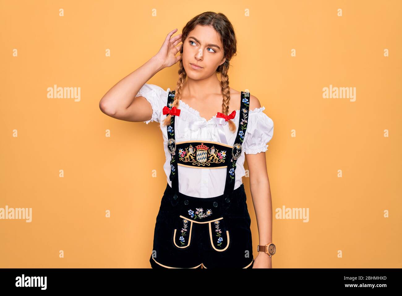 Young beautiful blonde german woman with blue eyes wearing traditional ...