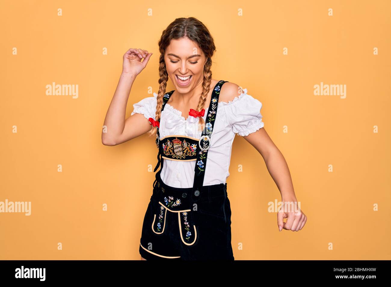 Young beautiful blonde german woman with blue eyes wearing traditional ...