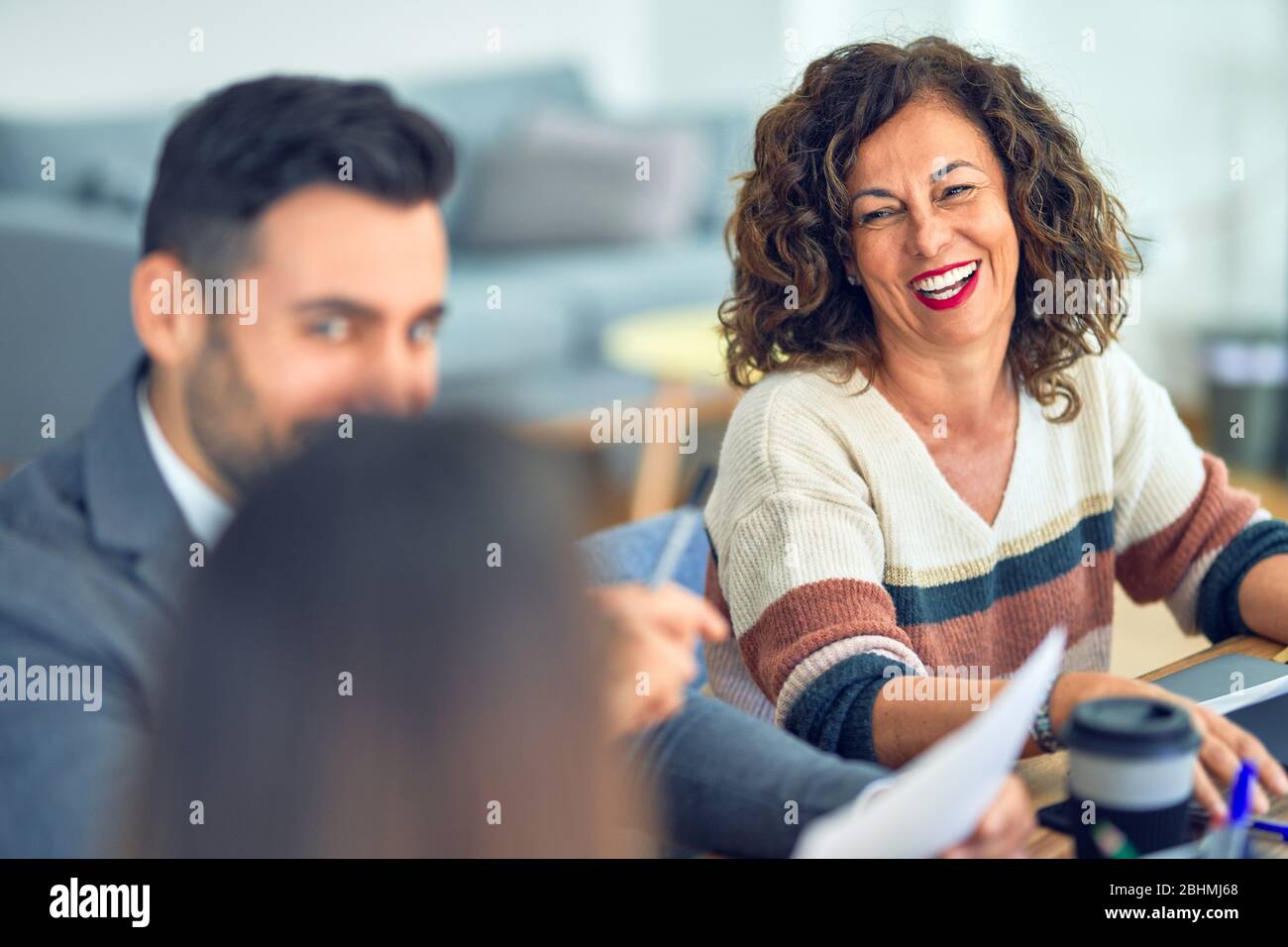 Group of business workers smiling happy working together. Sitting on ...