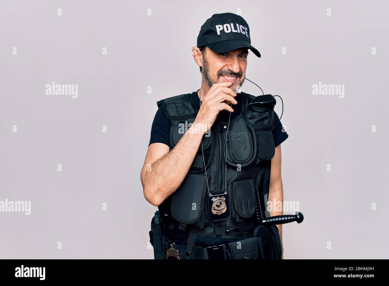 Middle age policeman wearing police uniform and bulletproof vest over ...