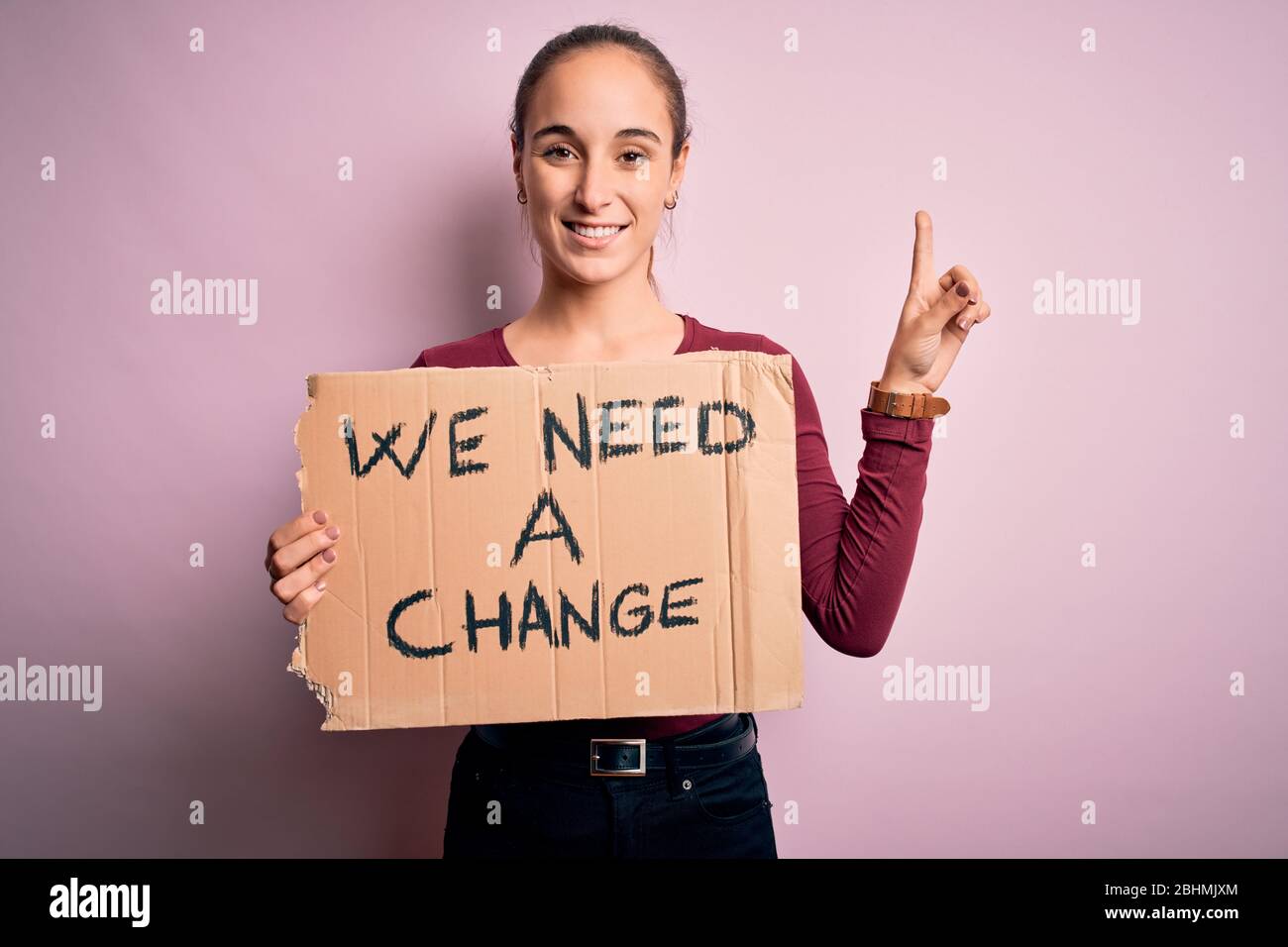 Young beautiful activist woman asking for change protesting holding ...
