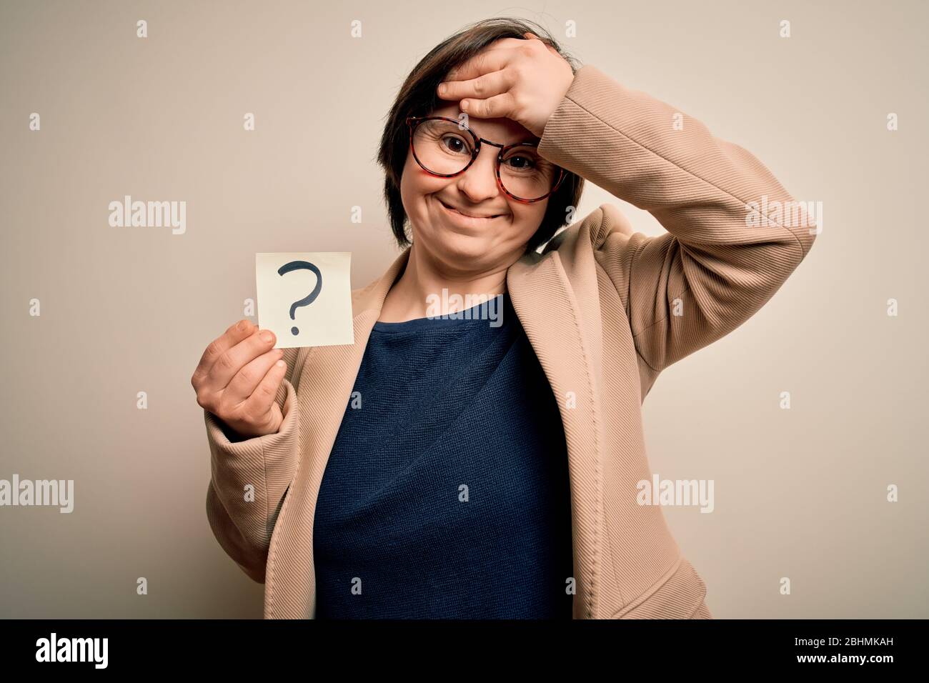 Young down syndrome business woman holding question mark paper as doubt ...