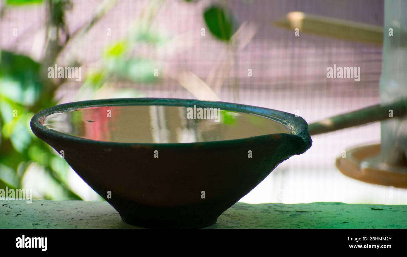 water in clay pot for birds in hot summer Stock Photo - Alamy