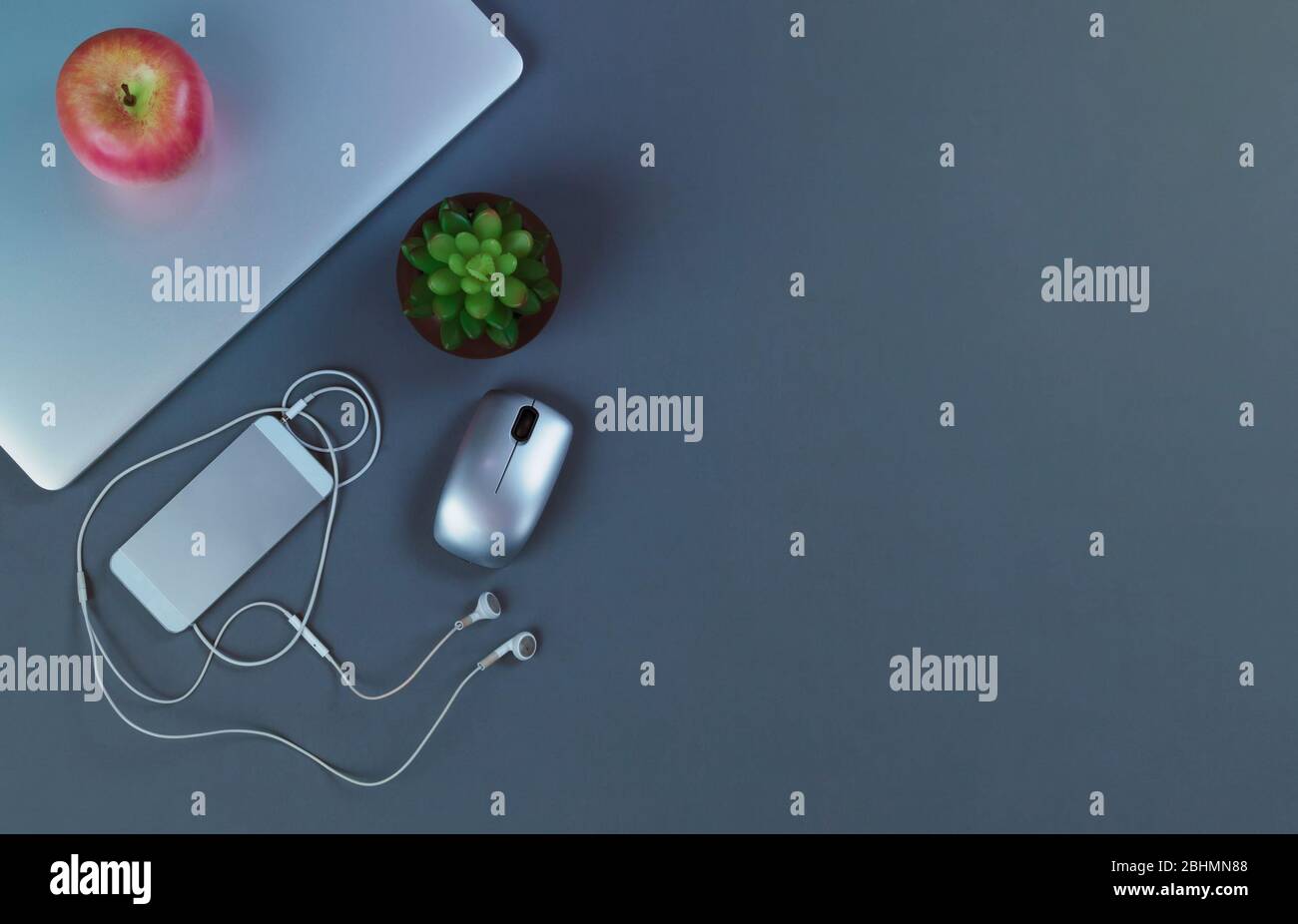 Gray desktop with mobile devices in flat lay format for telework or ...