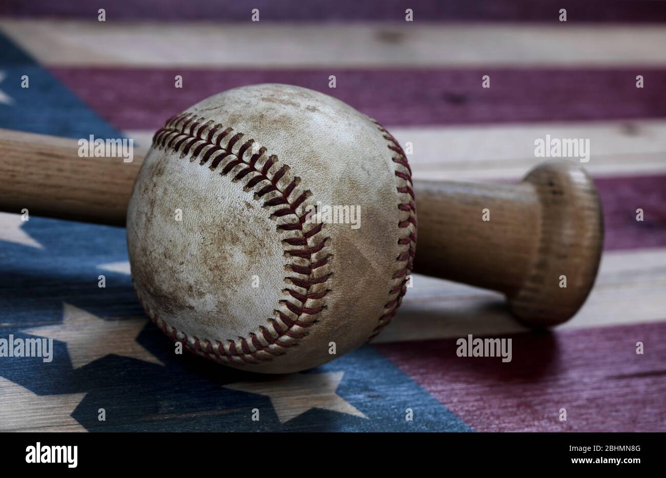 Closeup view of an old baseball and traditional wood bat on rustic ...