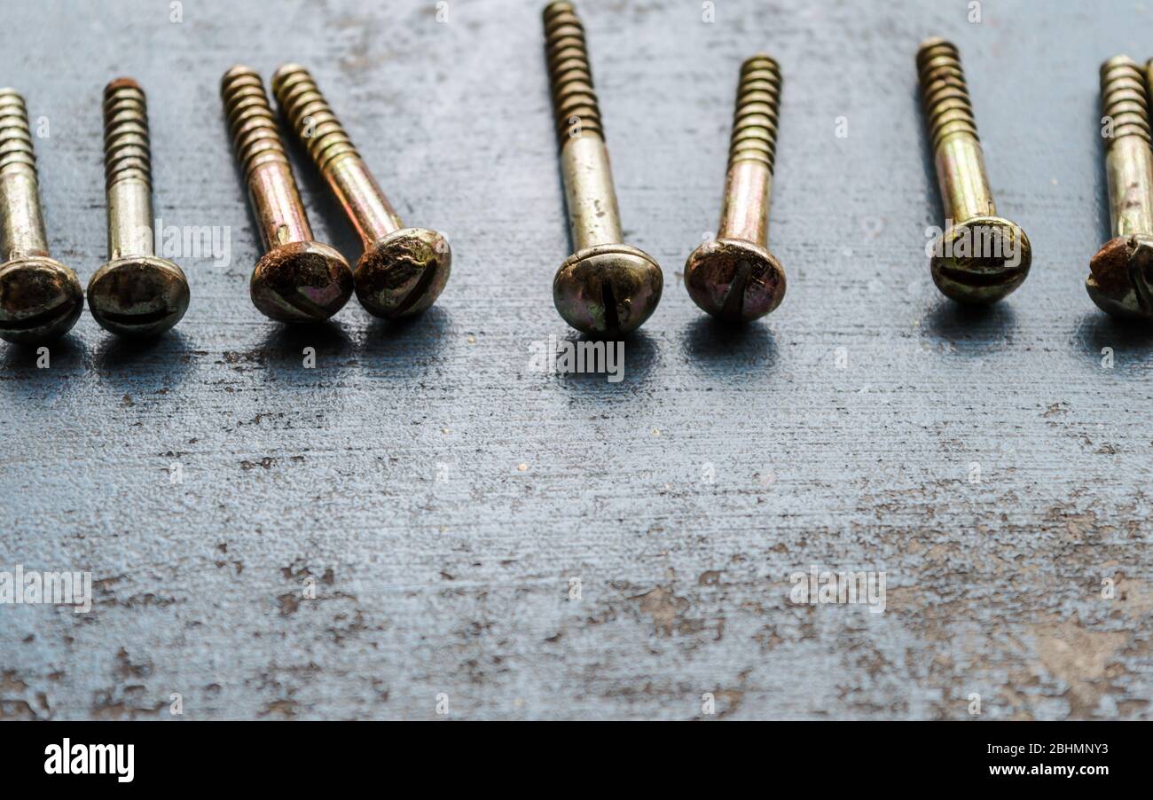 Screw on rusty metallic surface. Close Up. Screws Industrial Background ...