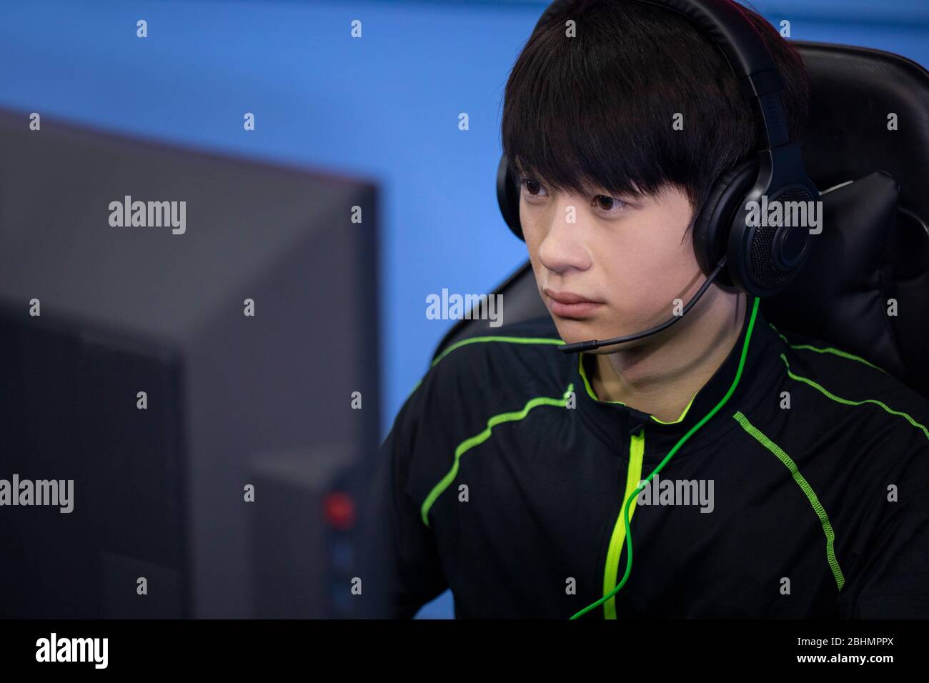 Young Chinese man playing esports Stock Photo - Alamy