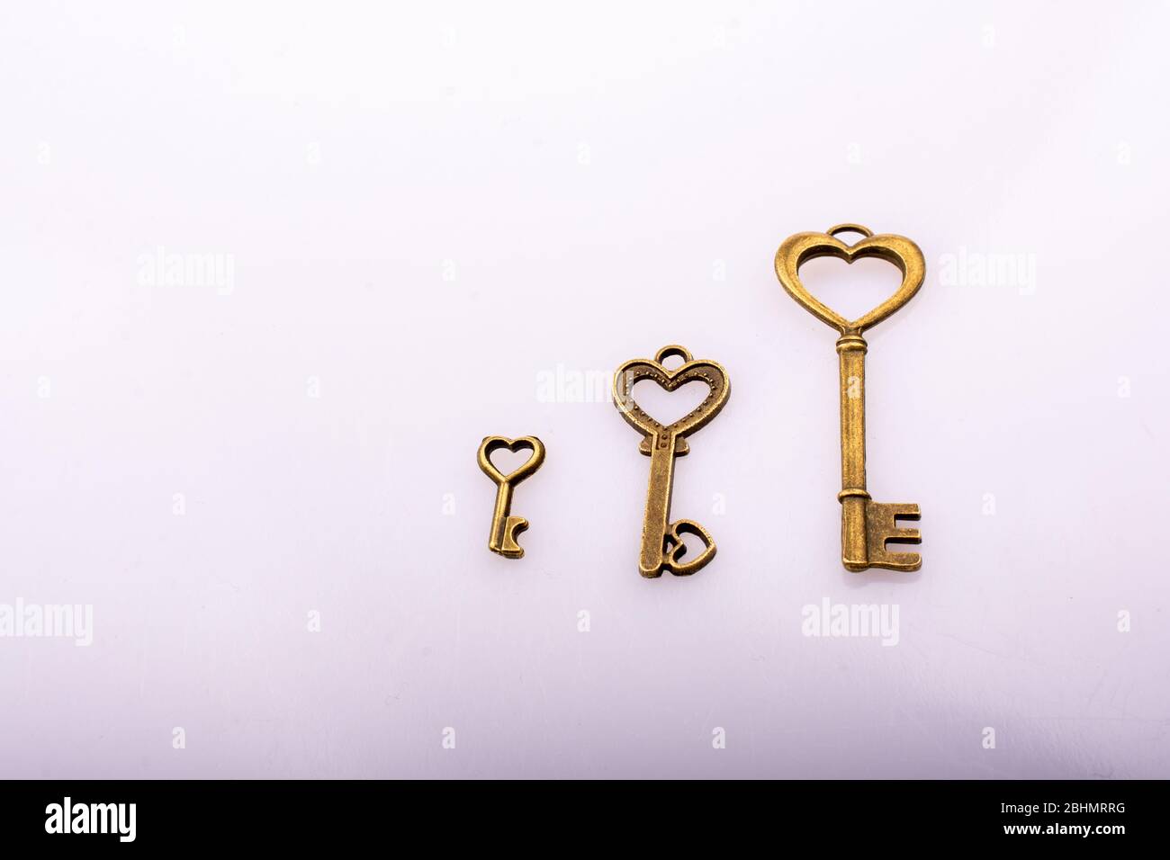 Heart shaped retro metal keys on white background Stock Photo - Alamy