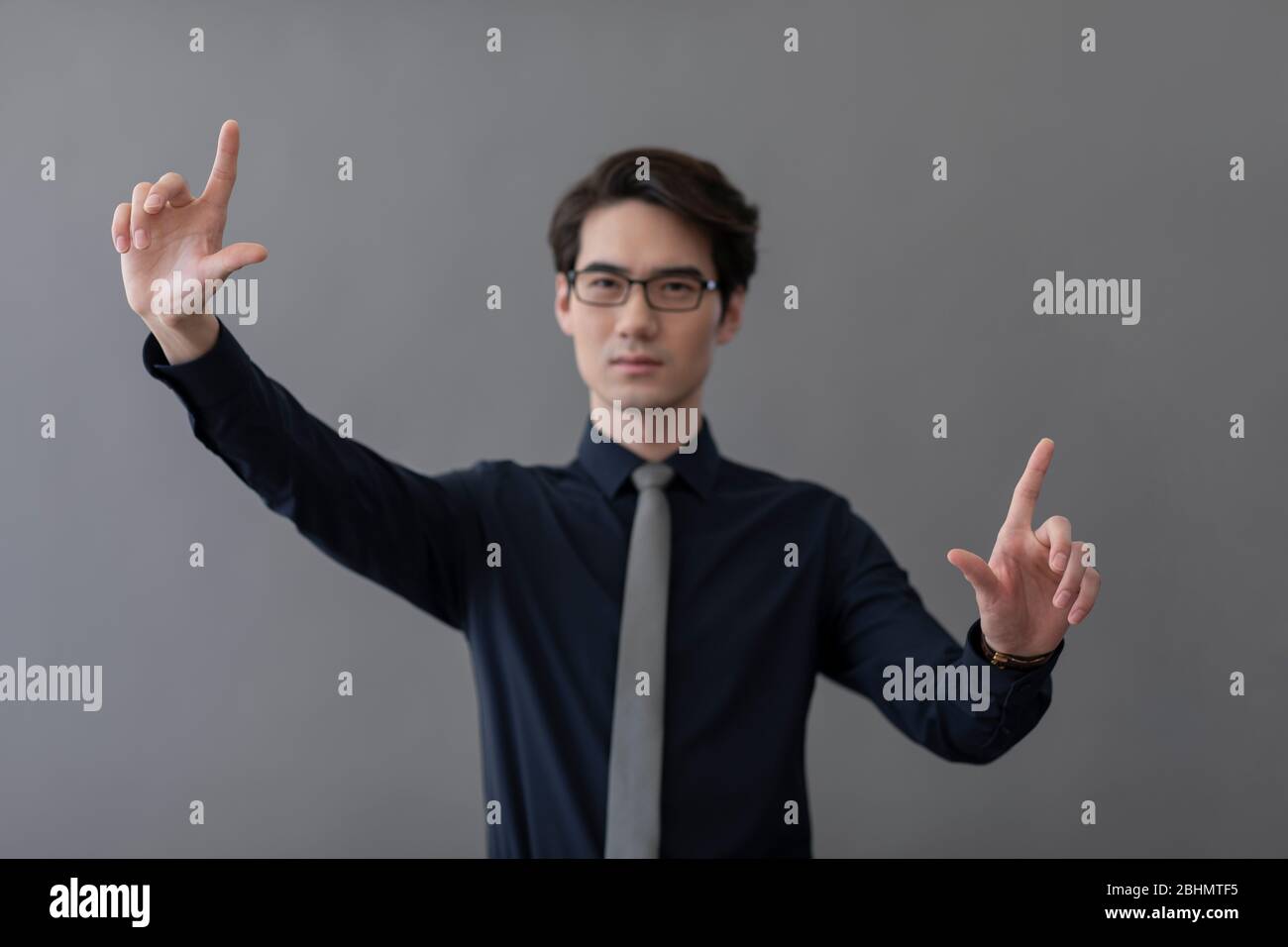 Young Chinese businessman using advanced touch screen technology Stock ...