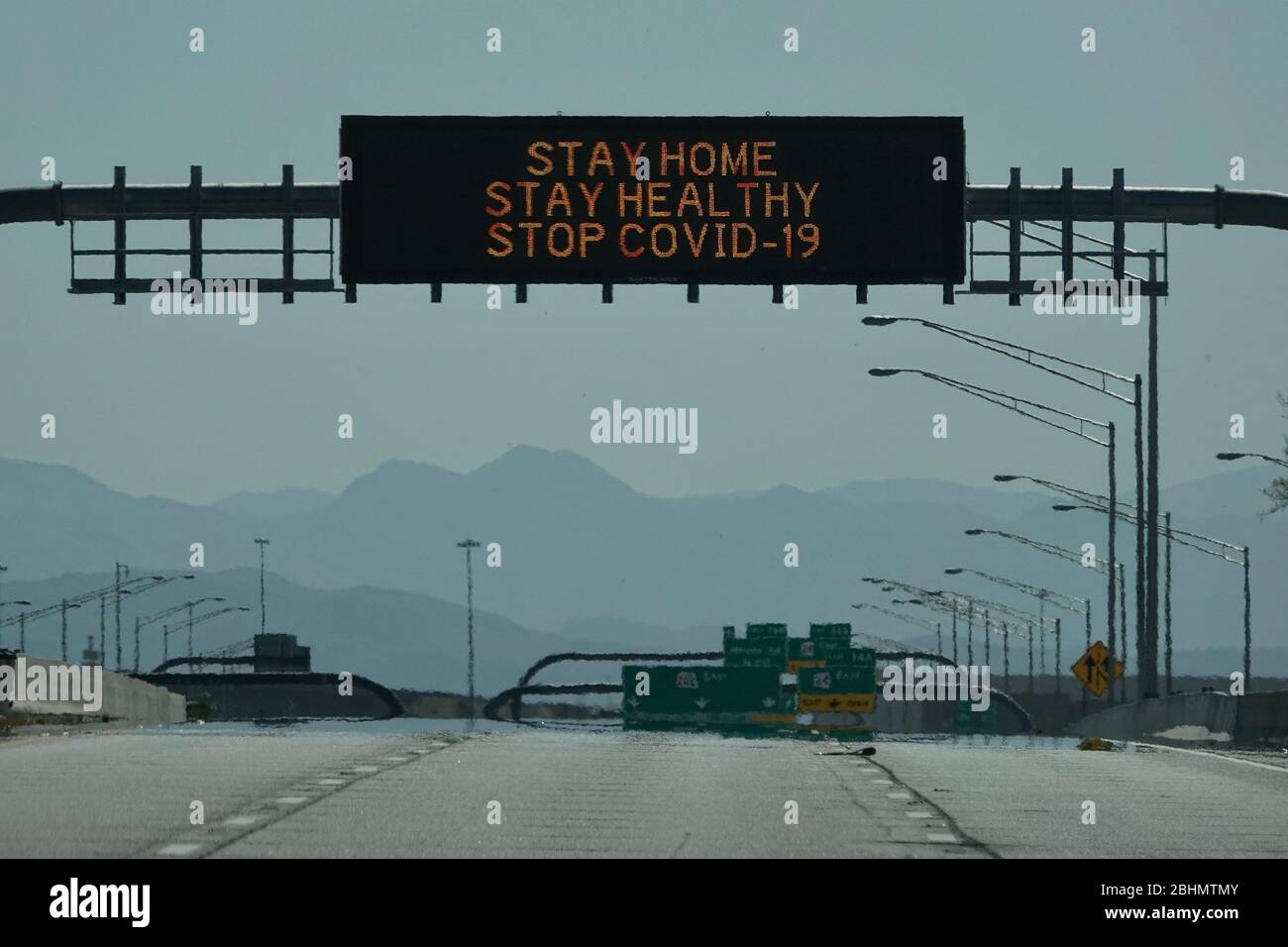 A freeway sign warns people to stay home to stop the spread of covid-19 ...