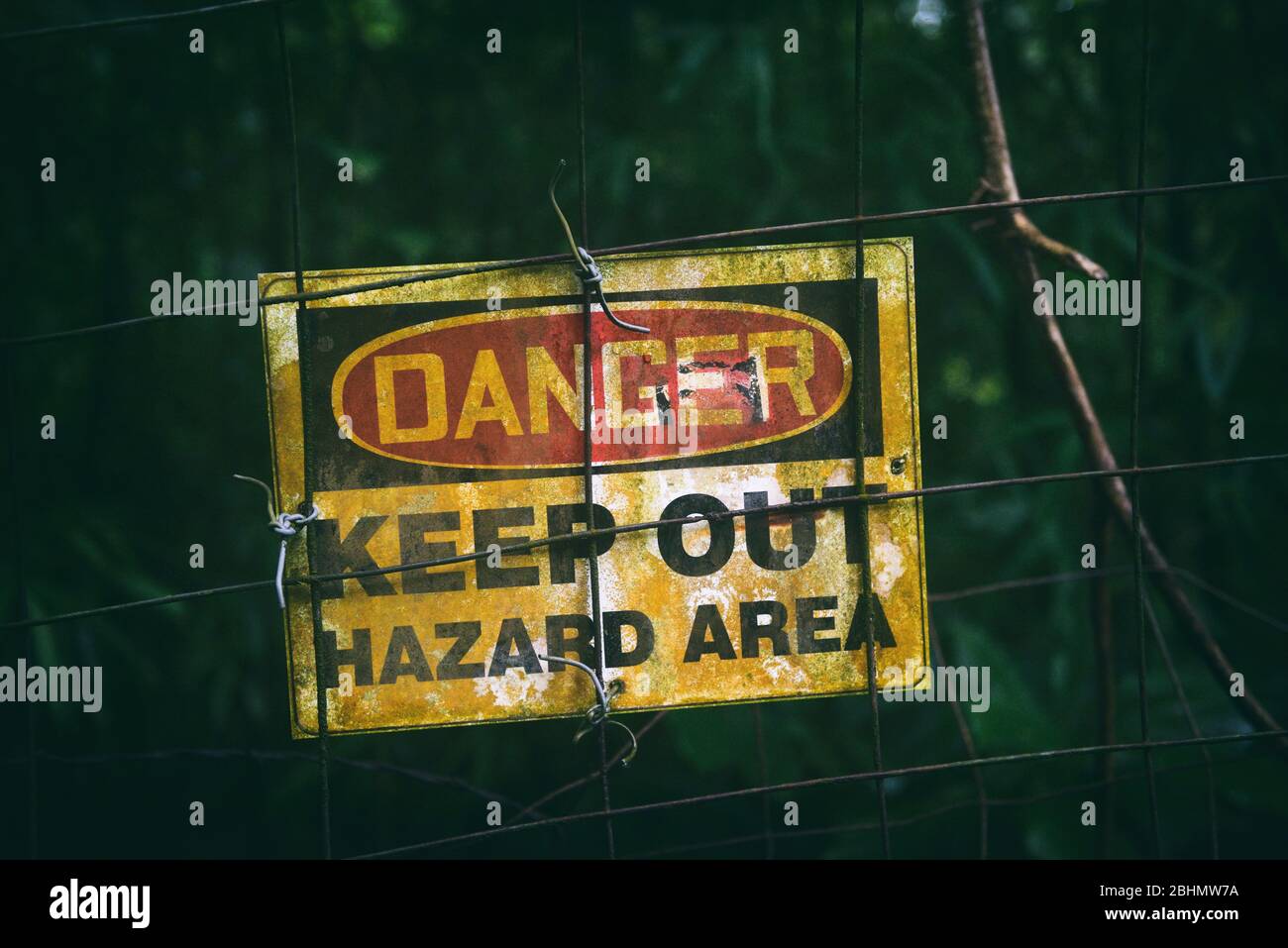 Danger sign with text KEEP OUT HAZARD AREA as warning message hanging ...