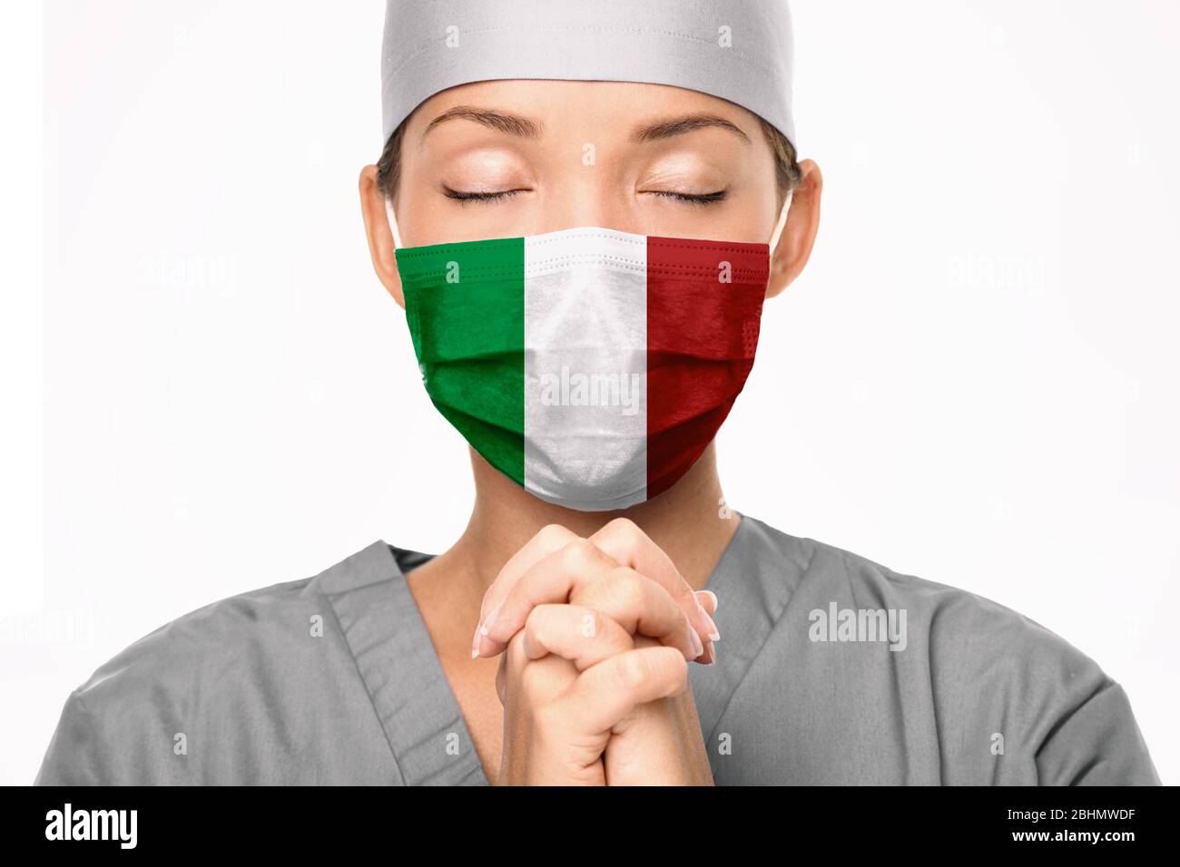 Italy flag print on surgical mask. Doctor praying for help. Young Asian ...