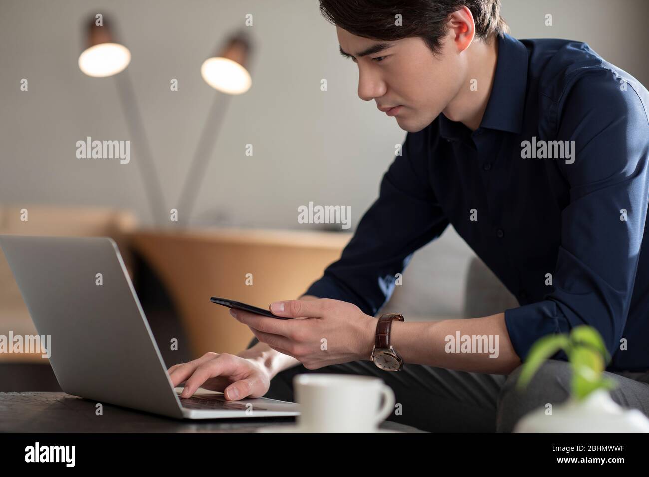 Young chinese businessman using laptop hi-res stock photography and images - Alamy