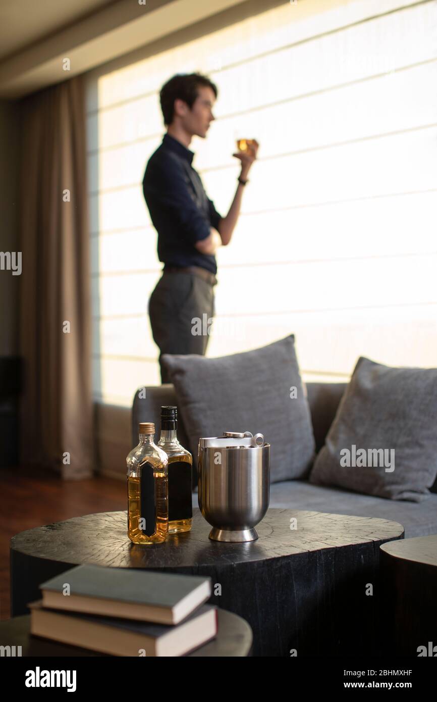 Young Chinese businessman drinking alcohol in front of window Stock ...