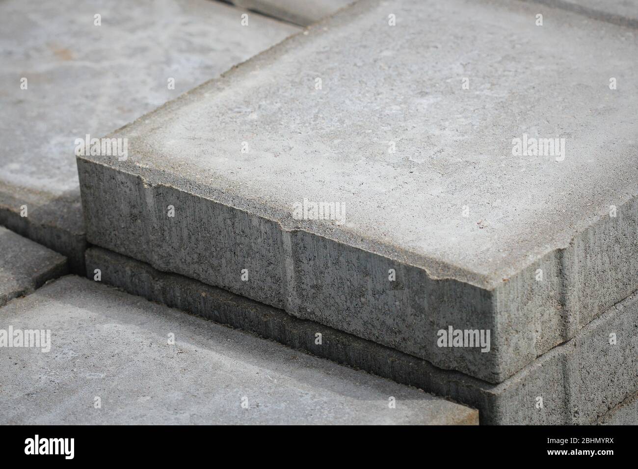 Stack of gray paving slabs. Laying the sidewalk of the tiles ...