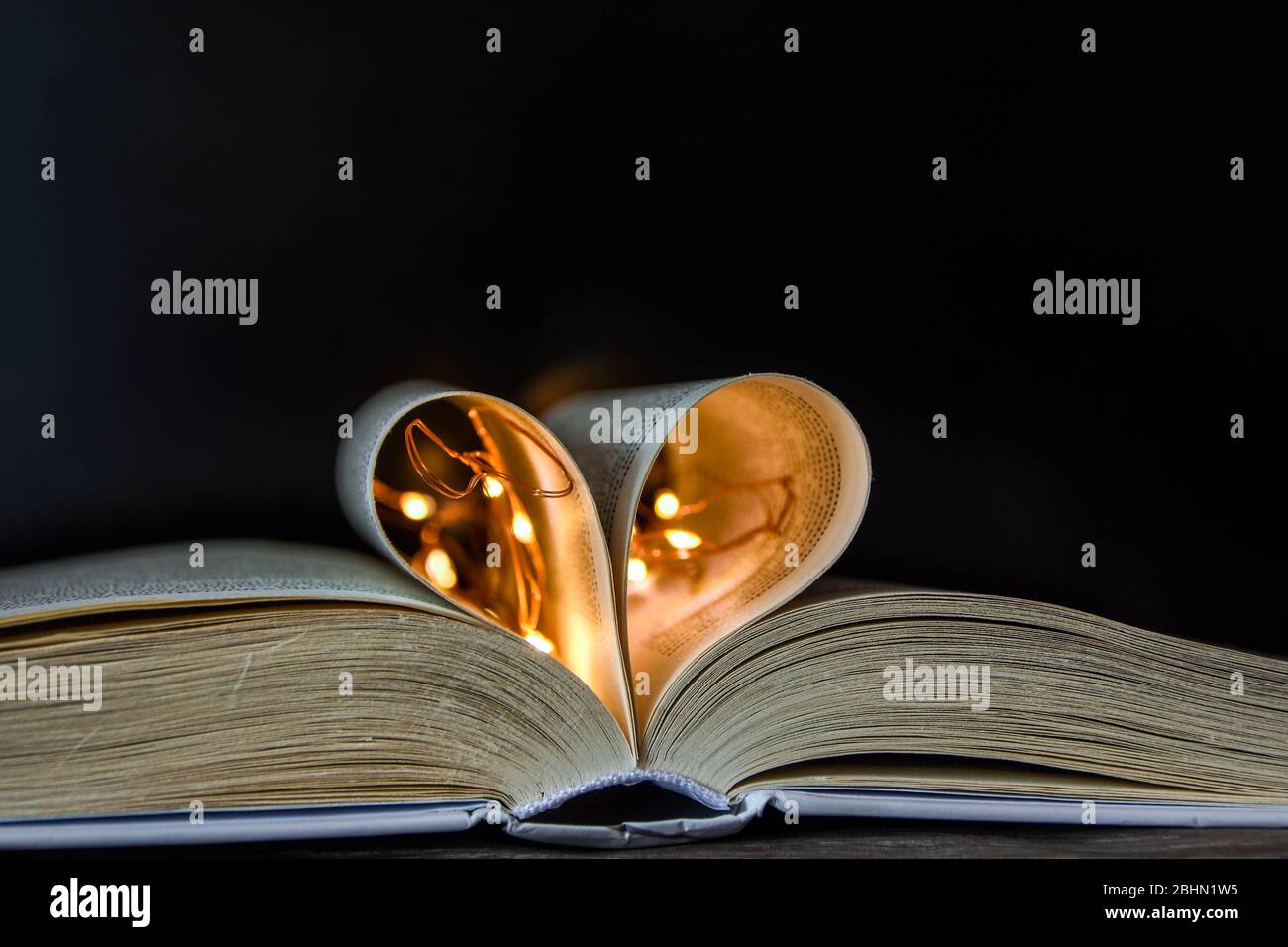 Book with love symbol isolated on black background, Close-up Of Heart ...