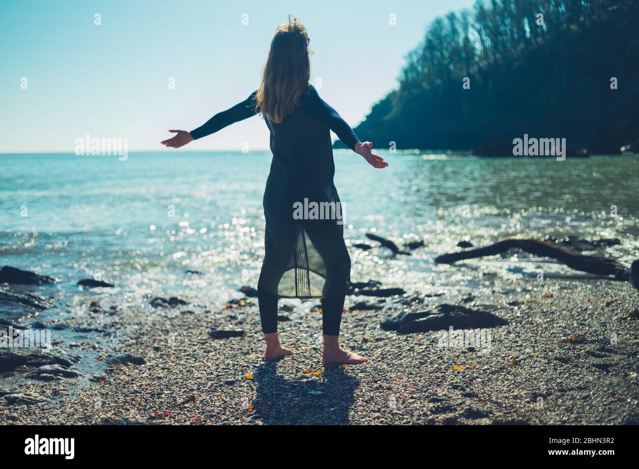 A joyful woman on the beach is raising her arms Stock Photo - Alamy A joyful woman on the beach is raising her arms Stock Photo - Alamy