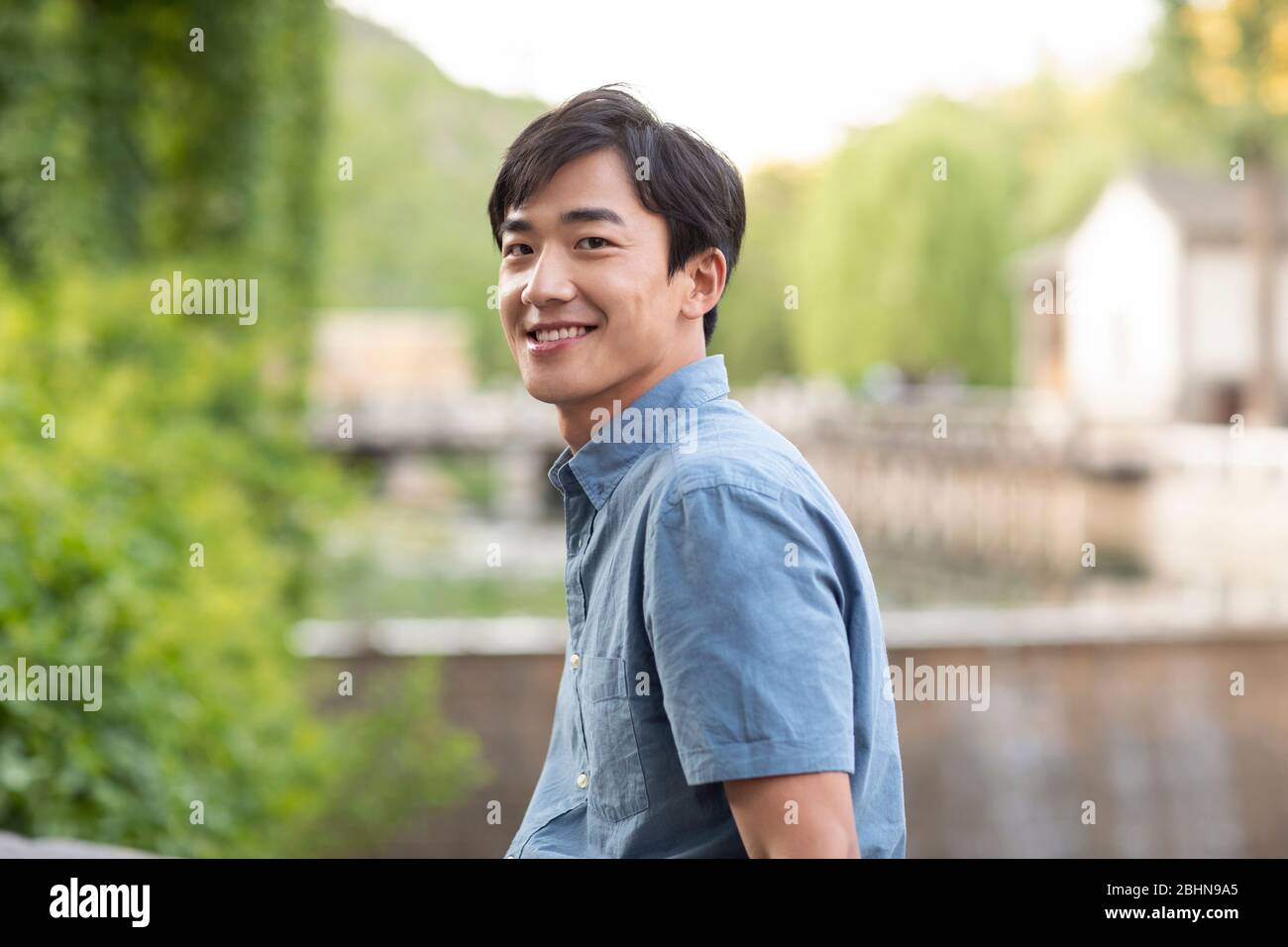 Happy young Chinese man enjoying vacation Stock Photo - Alamy