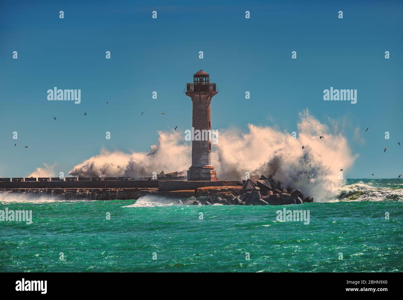 Waves crashing on Lighthouse Stock Photo - Alamy