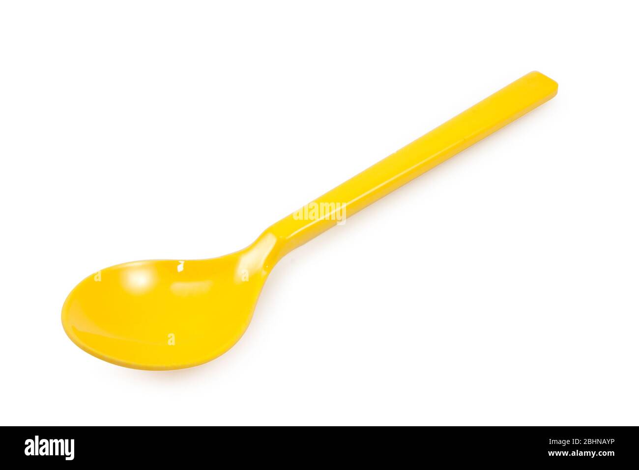 yellow plastic spoon on white background Stock Photo - Alamy