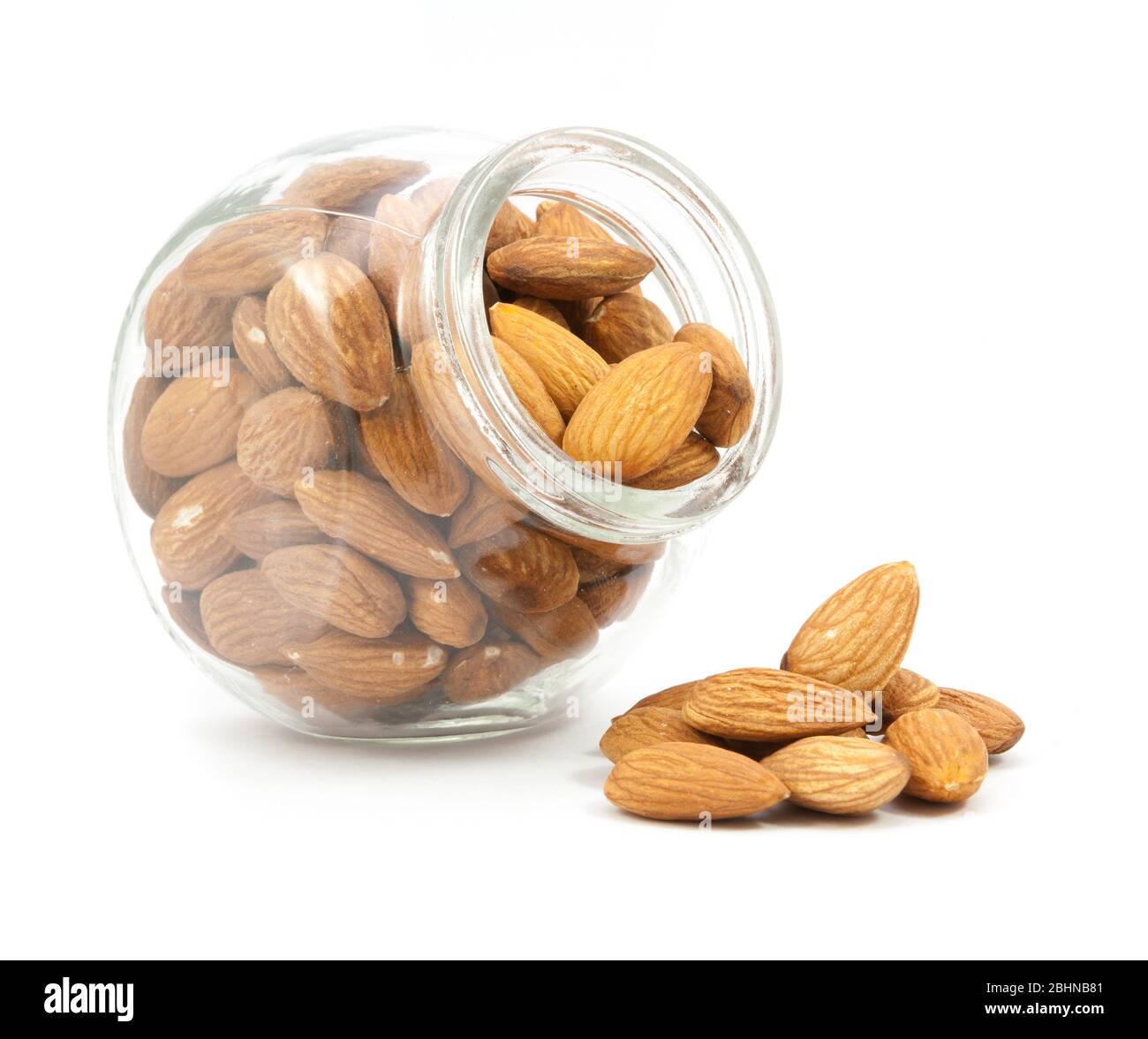 Glass jar of almonds isolated on white background Stock Photo - Alamy