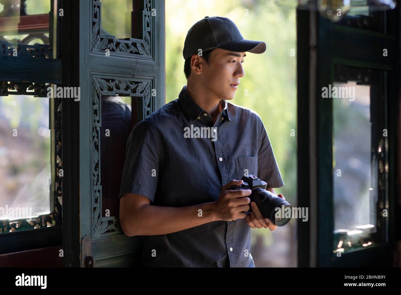 Young Chinese photographer using camera Stock Photo - Alamy