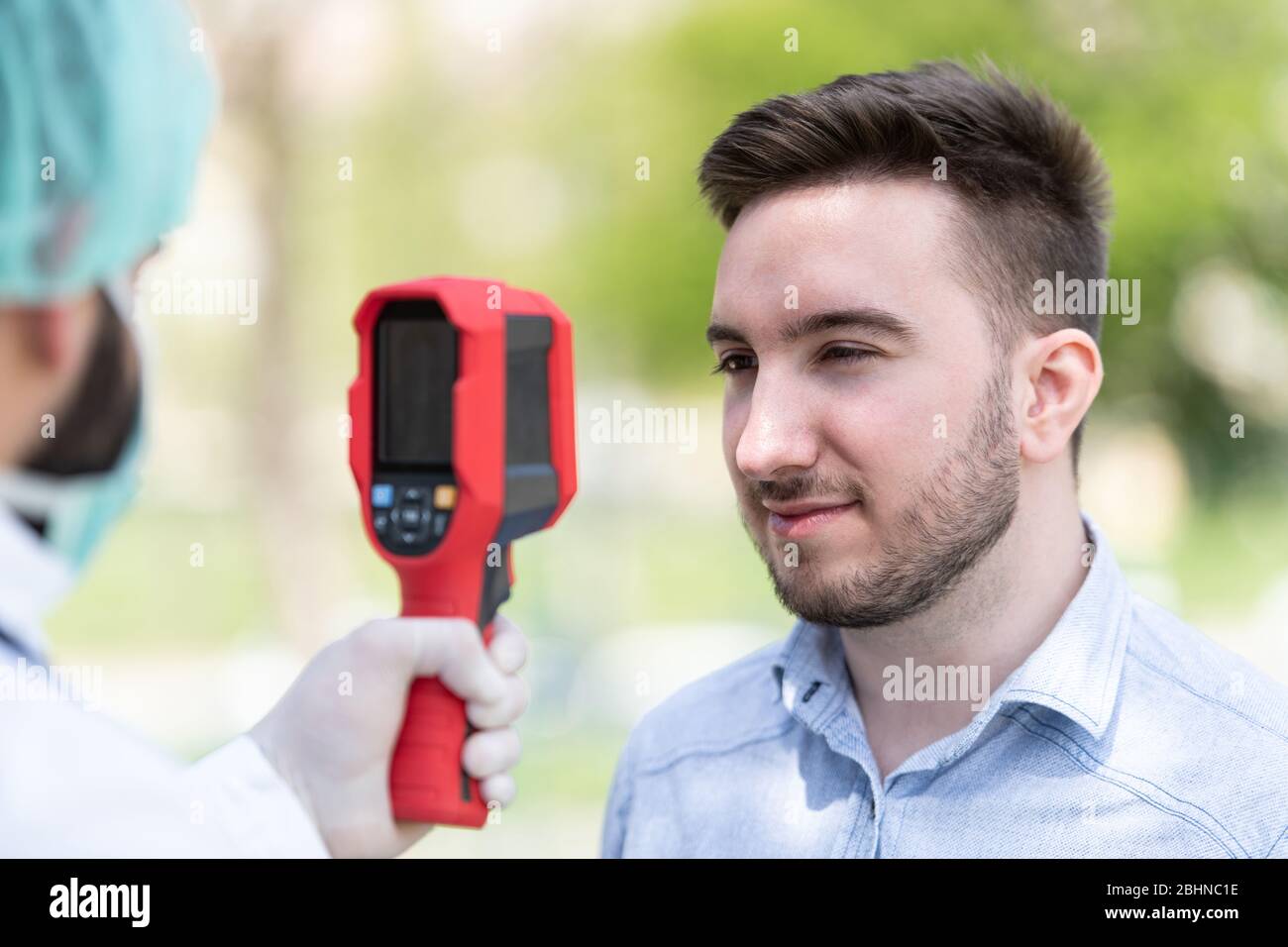 Doctor Man Use Infrared Forehead Thermometer Gun to Check Body ...