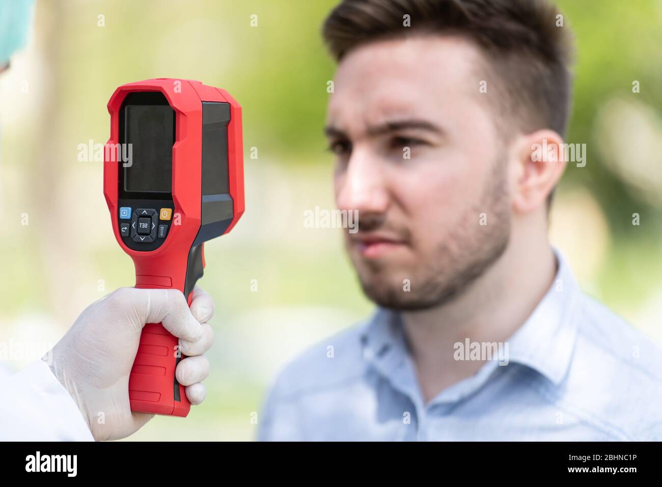 Doctor Man Use Infrared Forehead Thermometer Gun to Check Body ...