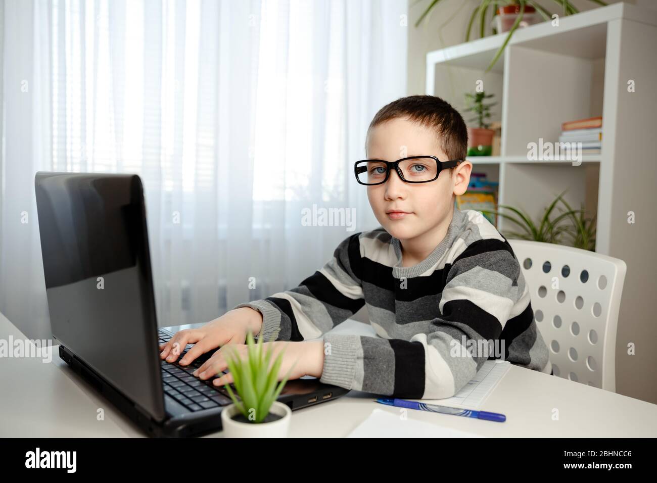 Online education and distance learning. Child doing school homework ...