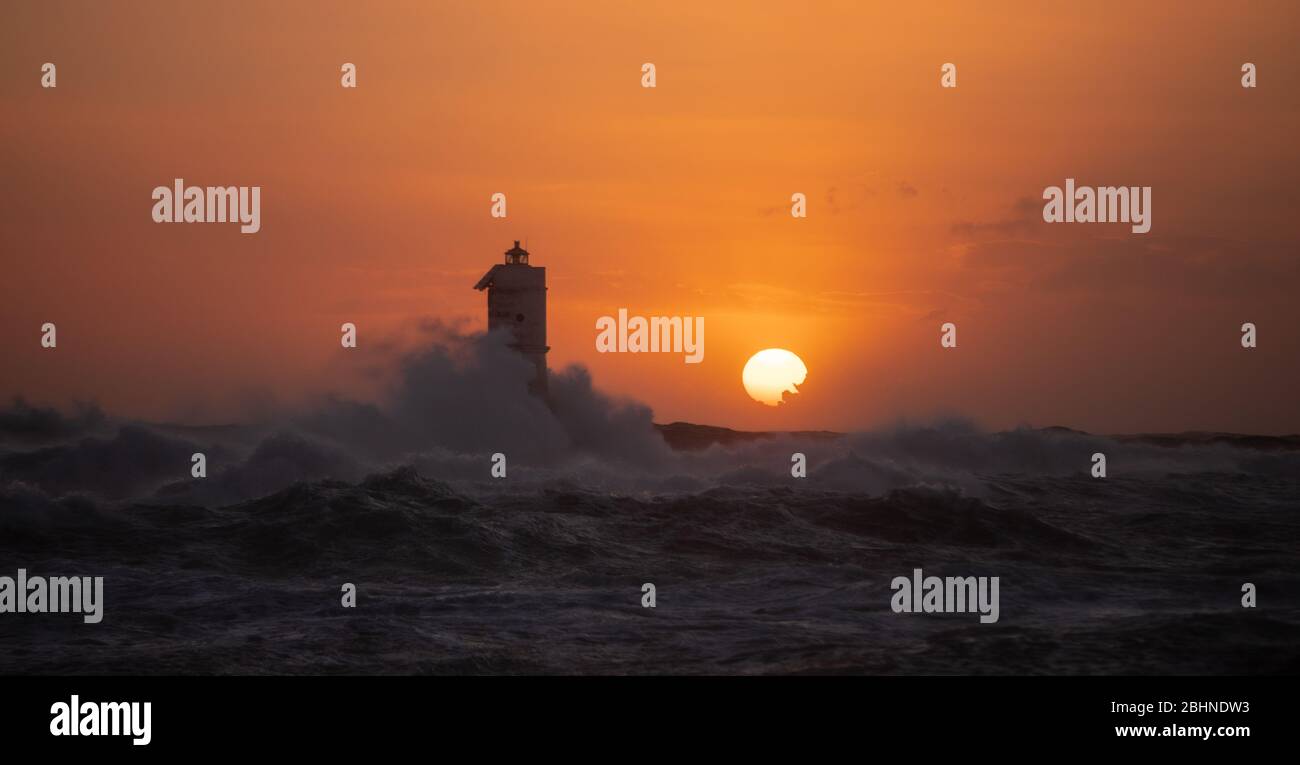The lighthouse of the Mangiabarche shrouded by the waves of a mistral ...