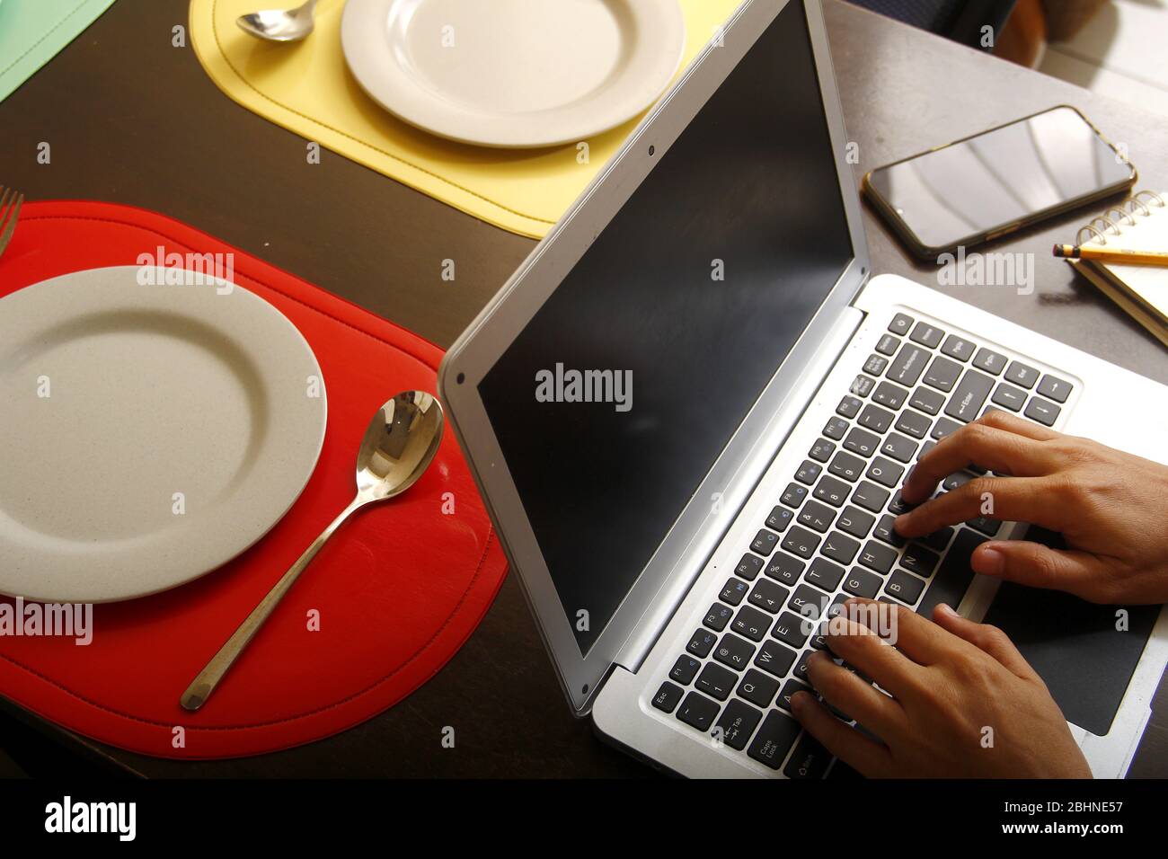 Photo of laptop computer with hands typing on it, smartphone, notebook ...