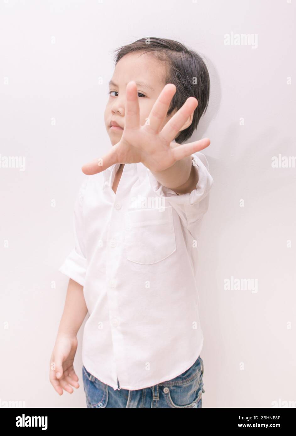 asian kid and hand raise stop written on his hand Stock Photo - Alamy