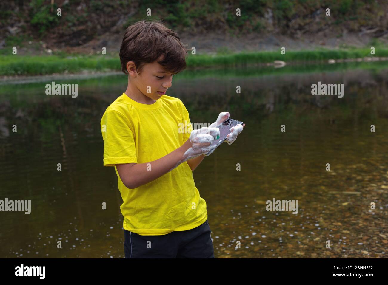 9-year-old boy holds soap camera and sponge in his hands. Childhood ...