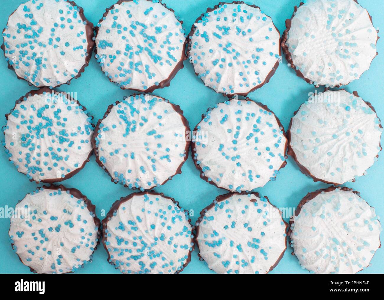 Blue marshmallows made from apple molasses with coconut on a blue ...
