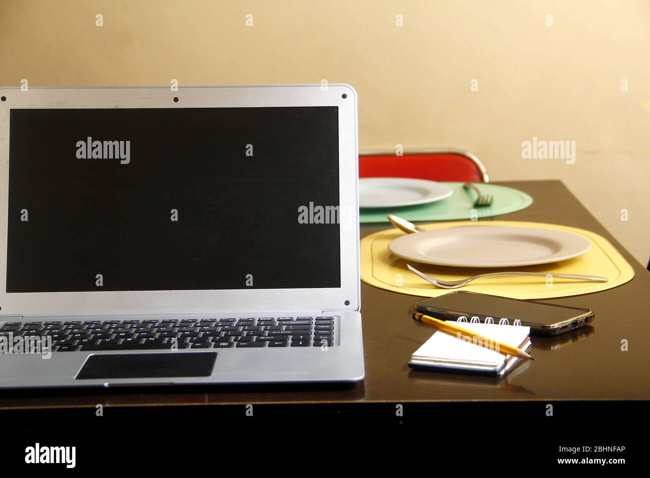 Photo of laptop computer, smartphone, notebook, pencil, plates and ...