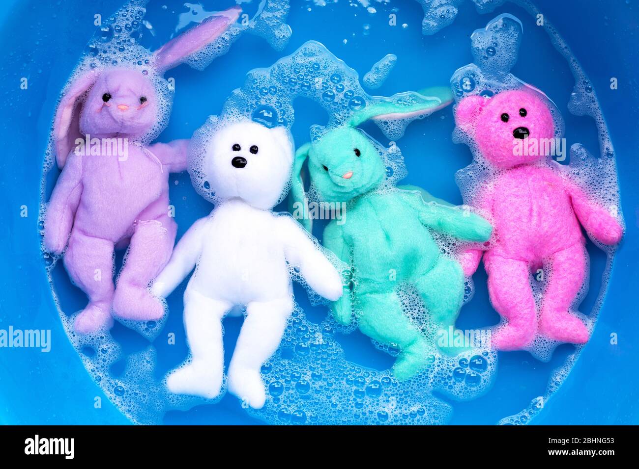 Soak rabbit doll with toy teddy bear in laundry detergent water ...